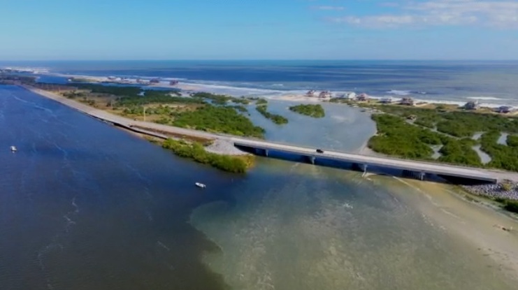 Beachfront homes nearly surrounded by water as waves breach sand near ...